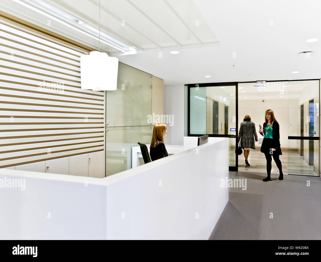 Cute girl coming to the reception area with lights and passing the door ...