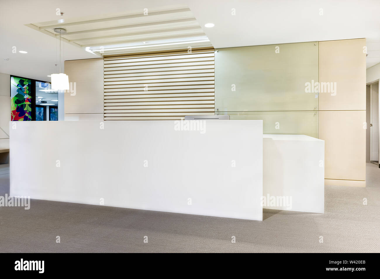 Modern reception office or building with lights on and white walls ...