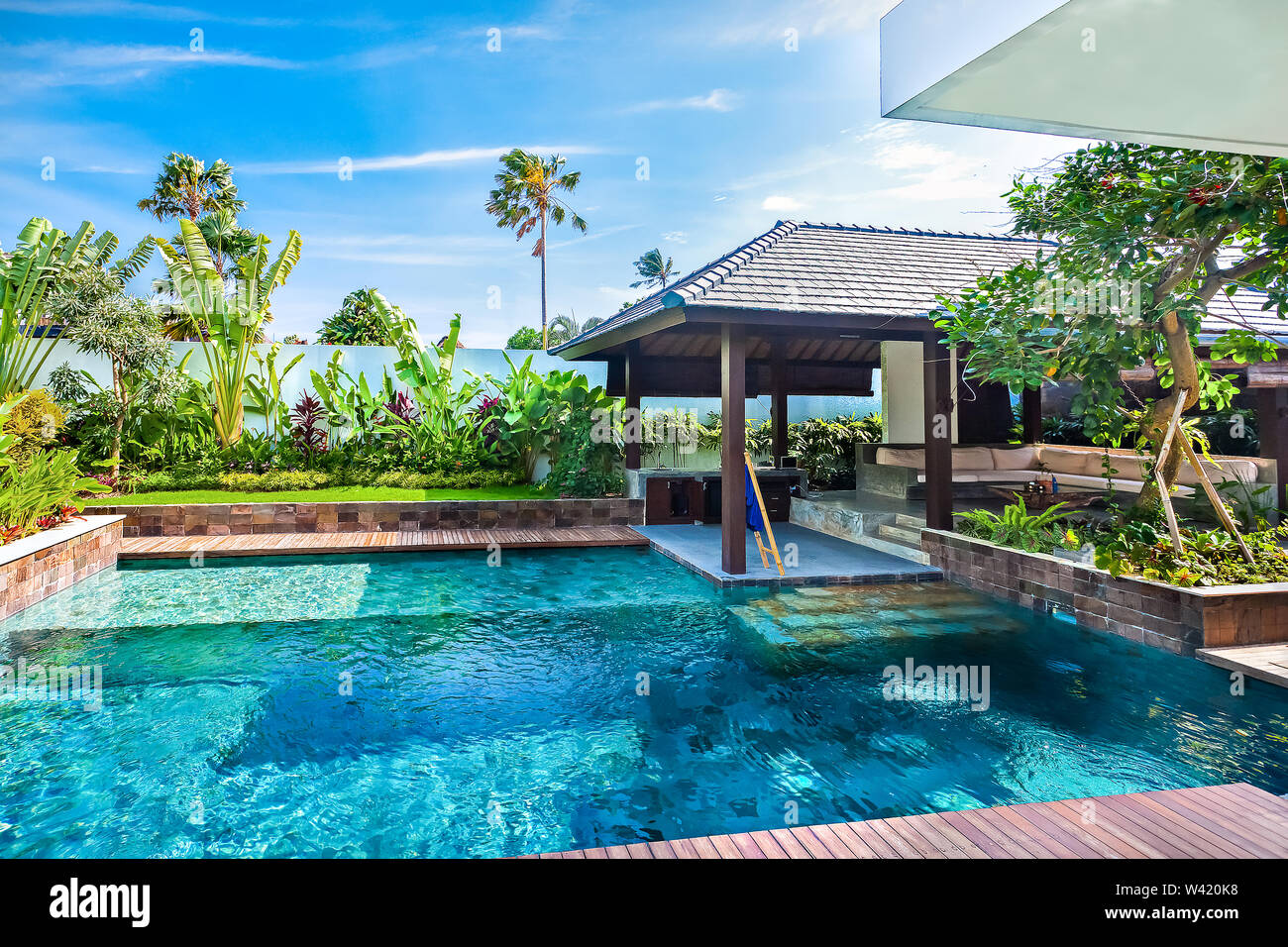 Colorful swimming pool with clear and blue water in a hotel with an ...