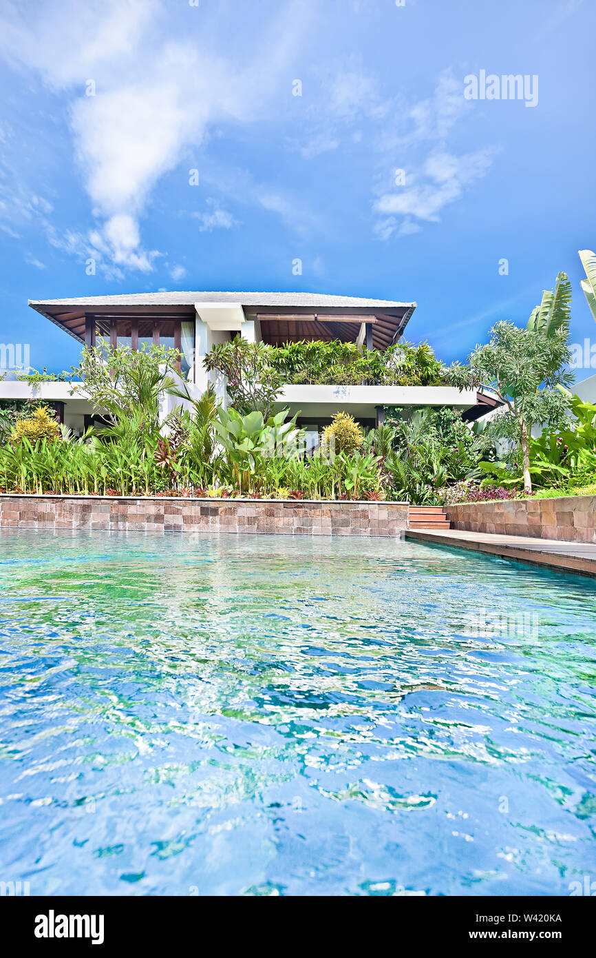 Modern swimming pool closeup in front of the luxury house with the blue ...