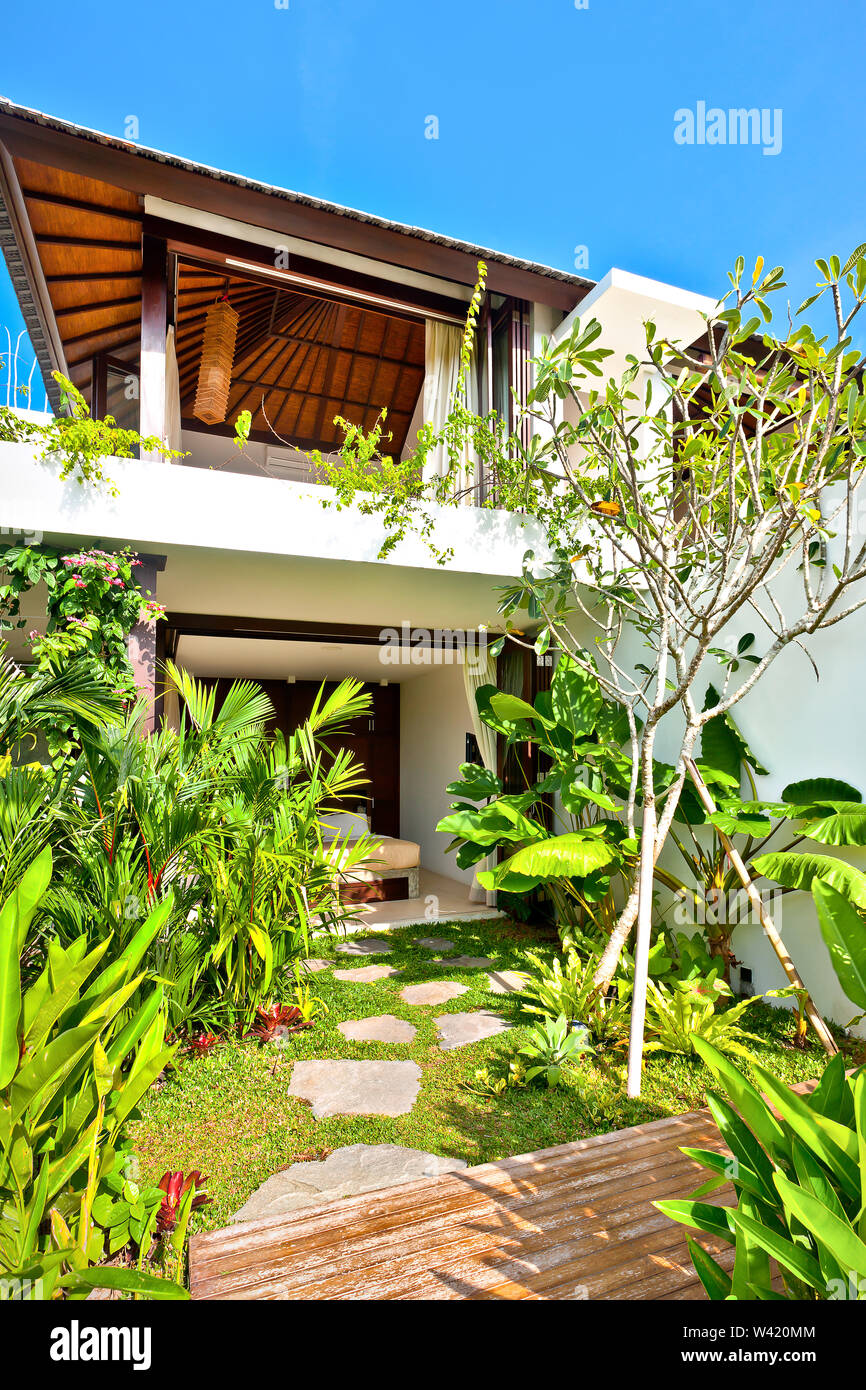 Entrance to a back of a modern house through the wooden pathway and ...