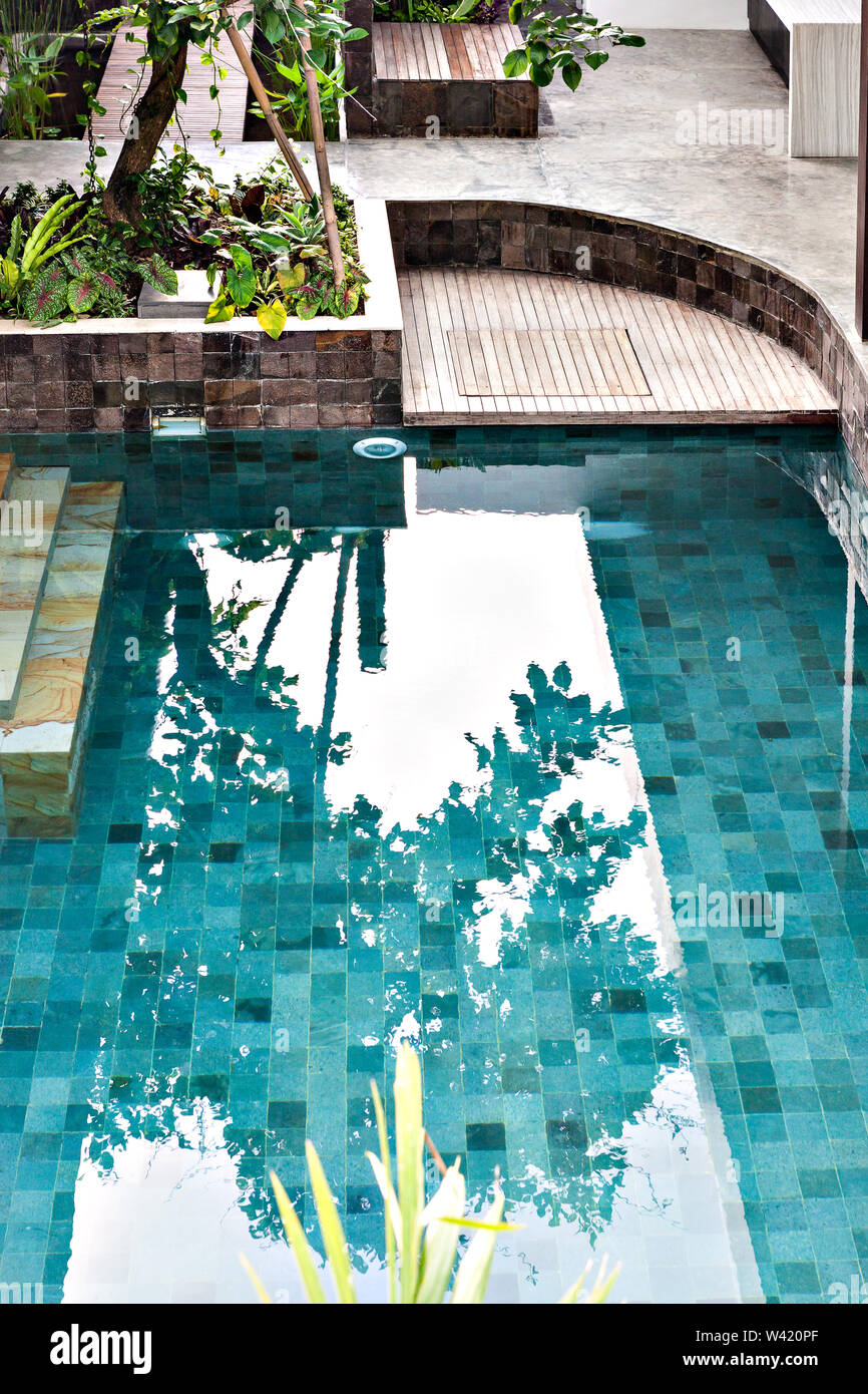 Clear swimming pool with still water in a garden with trees Stock Photo ...