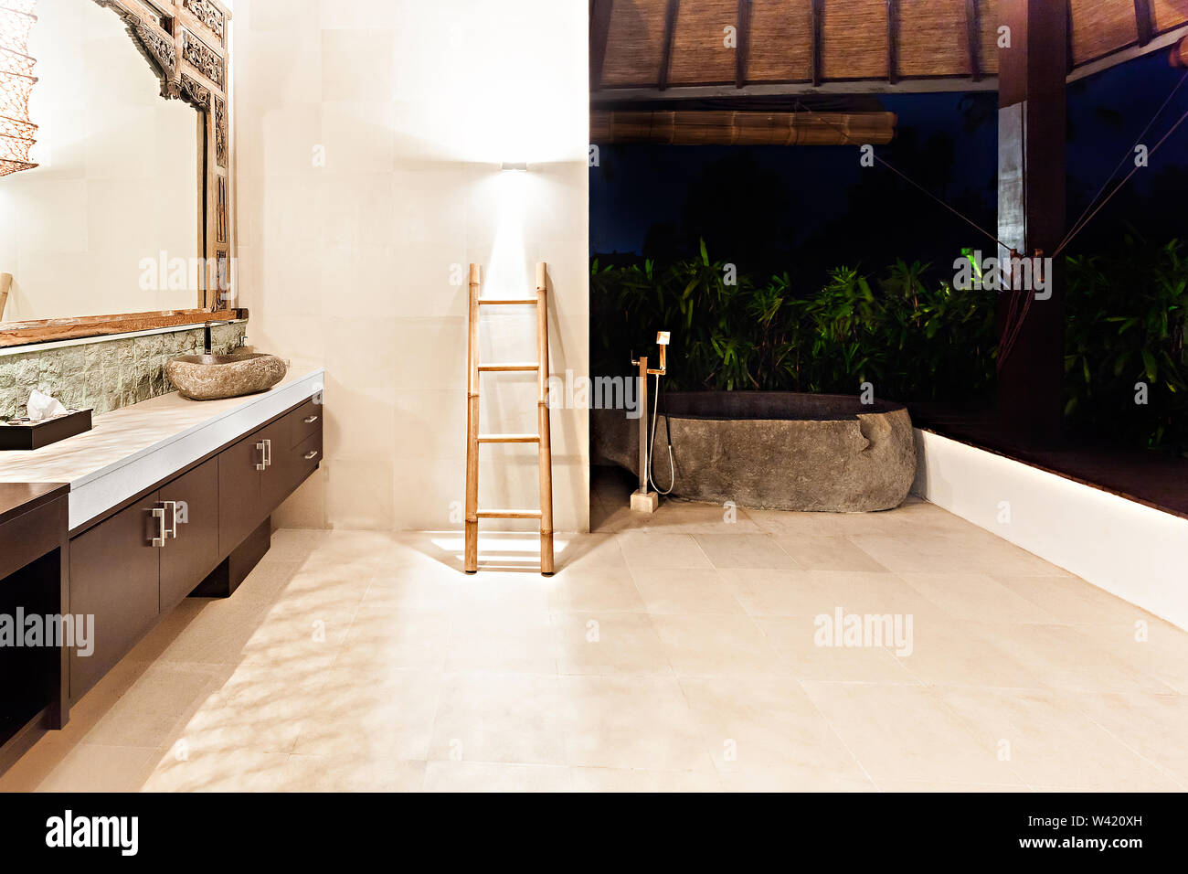 Outside washroom and bathing basin covered with trees in dark at night ...