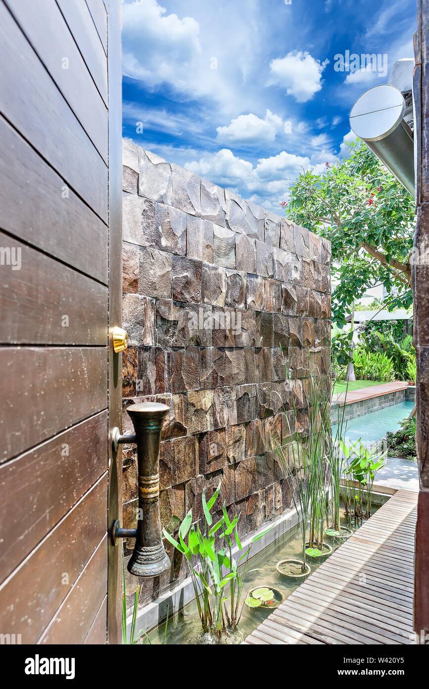 Entrance to a modern water pond from the inside with a brown wooden ...