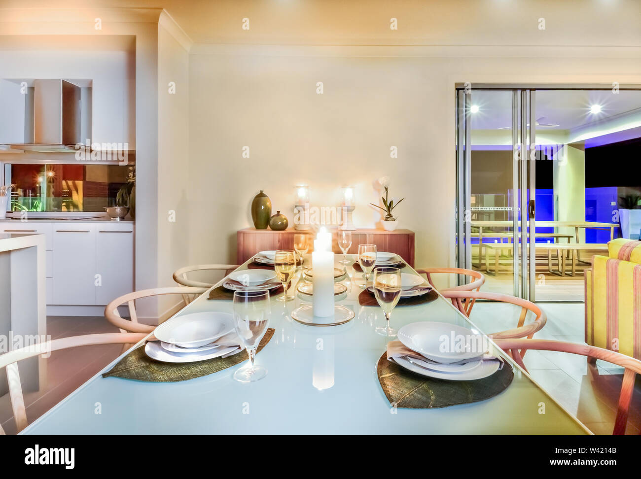 Dinner table setting in a modern house with candles, diner table, food ...