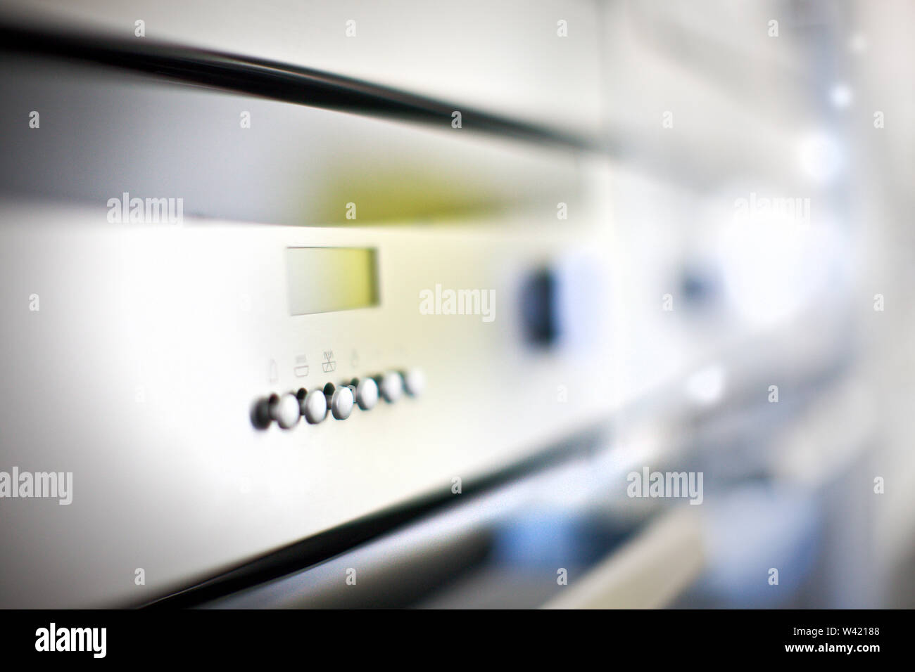 Modern stove control panel buttons on the bottom close up in a luxury ...