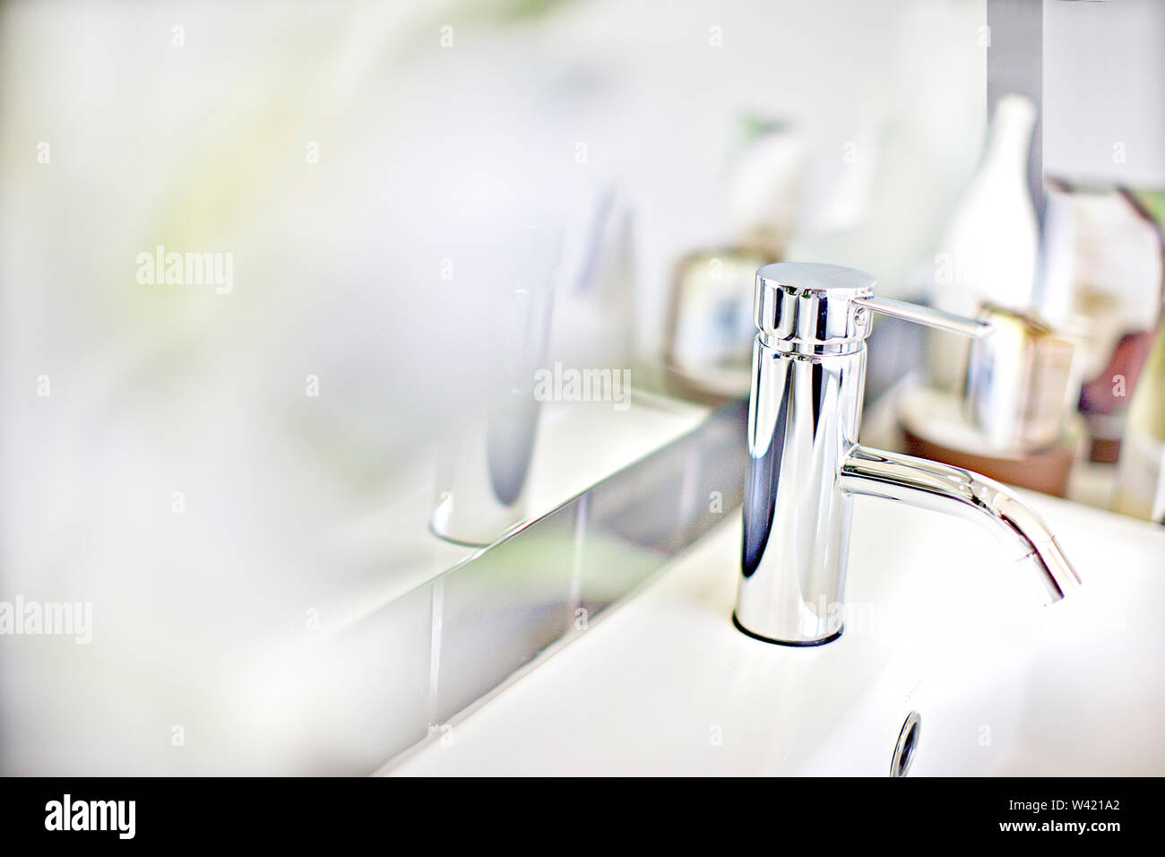 Silver faucet close up on the sink with a blurred background in a ...