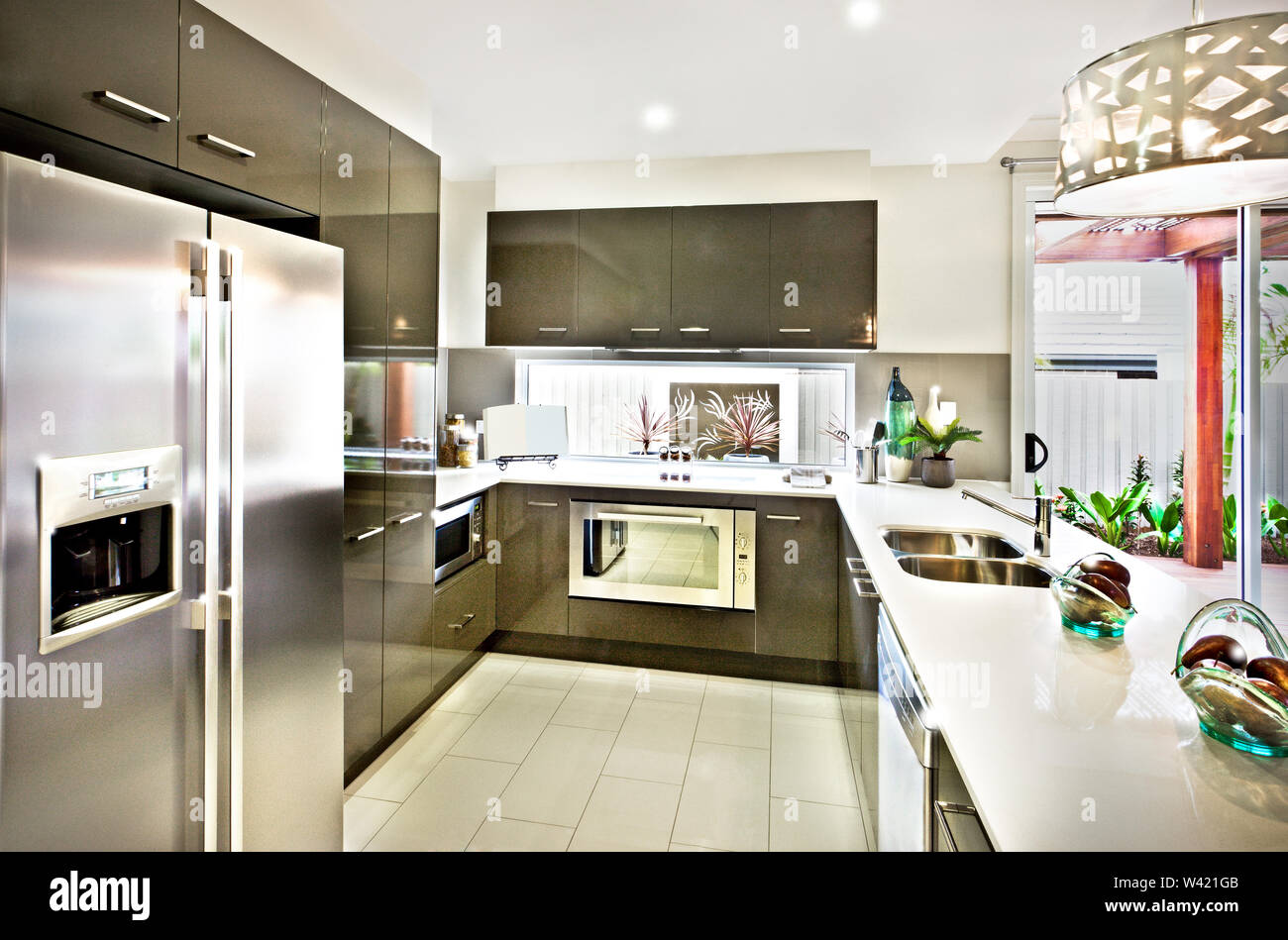 Modern glossy kitchen with silverware and shiny items including silver ...