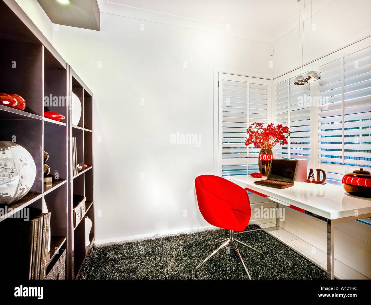 Functional study featuring a modern chair, a desk, and a bookshelf ...