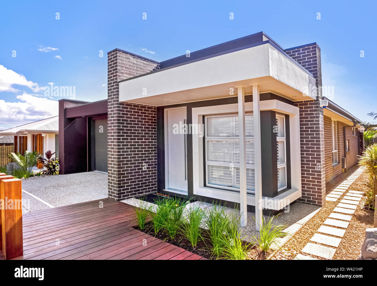 Splendid house exterior with brick-patterned wall, wooden passage, and ...