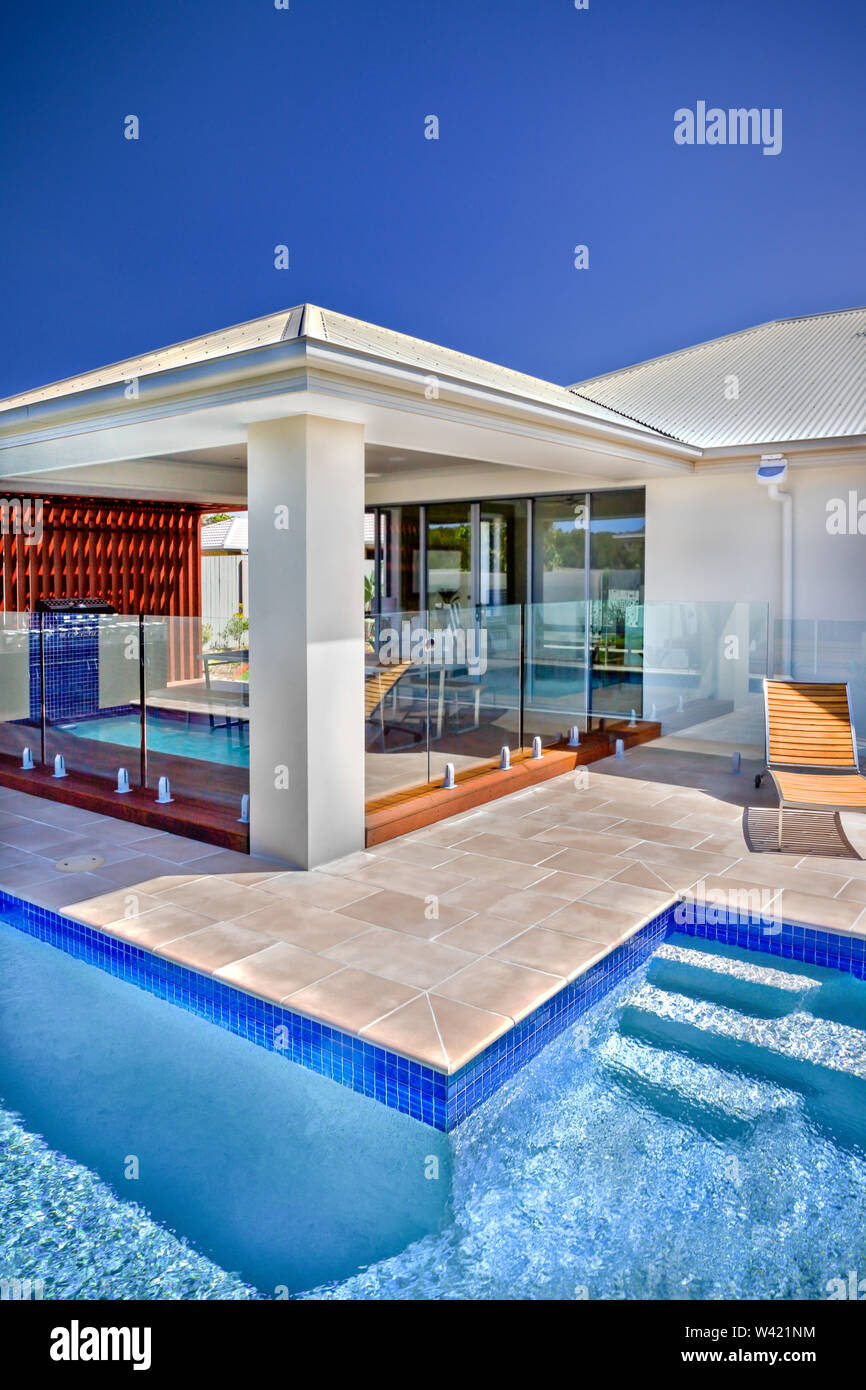 Sunlight spreads into the luxurious blue water swimming pool and point ...