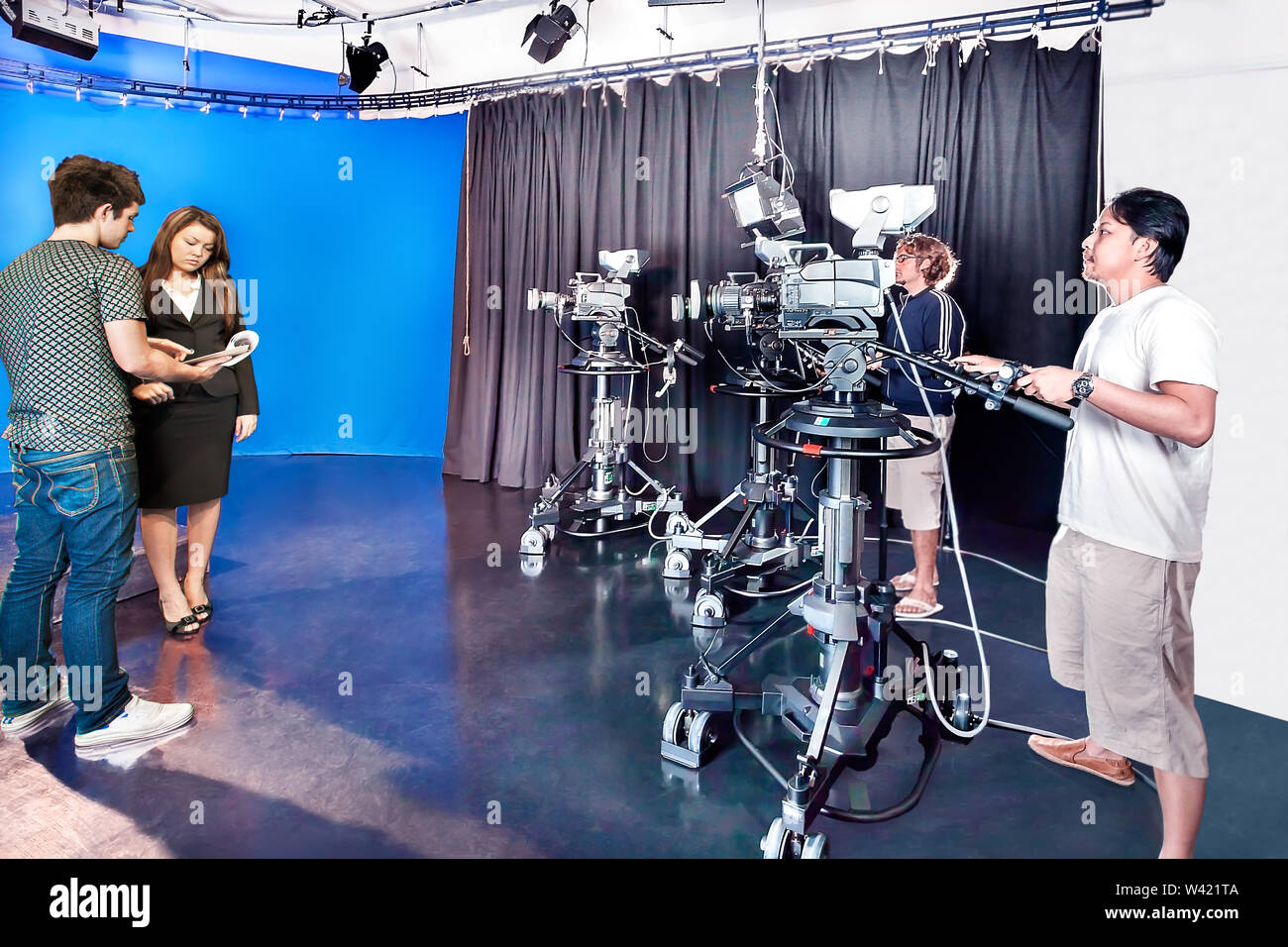 Newsreader ready broadcasting and looking the script in a studio with ...