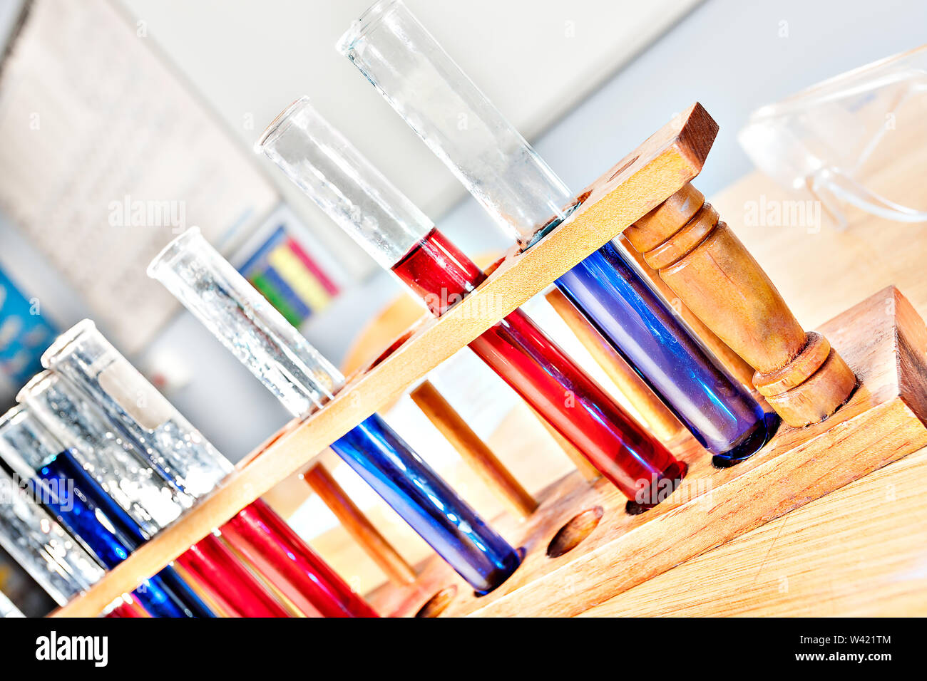 Sample test tubes with liquid in a wooden rack at a science laboratory ...