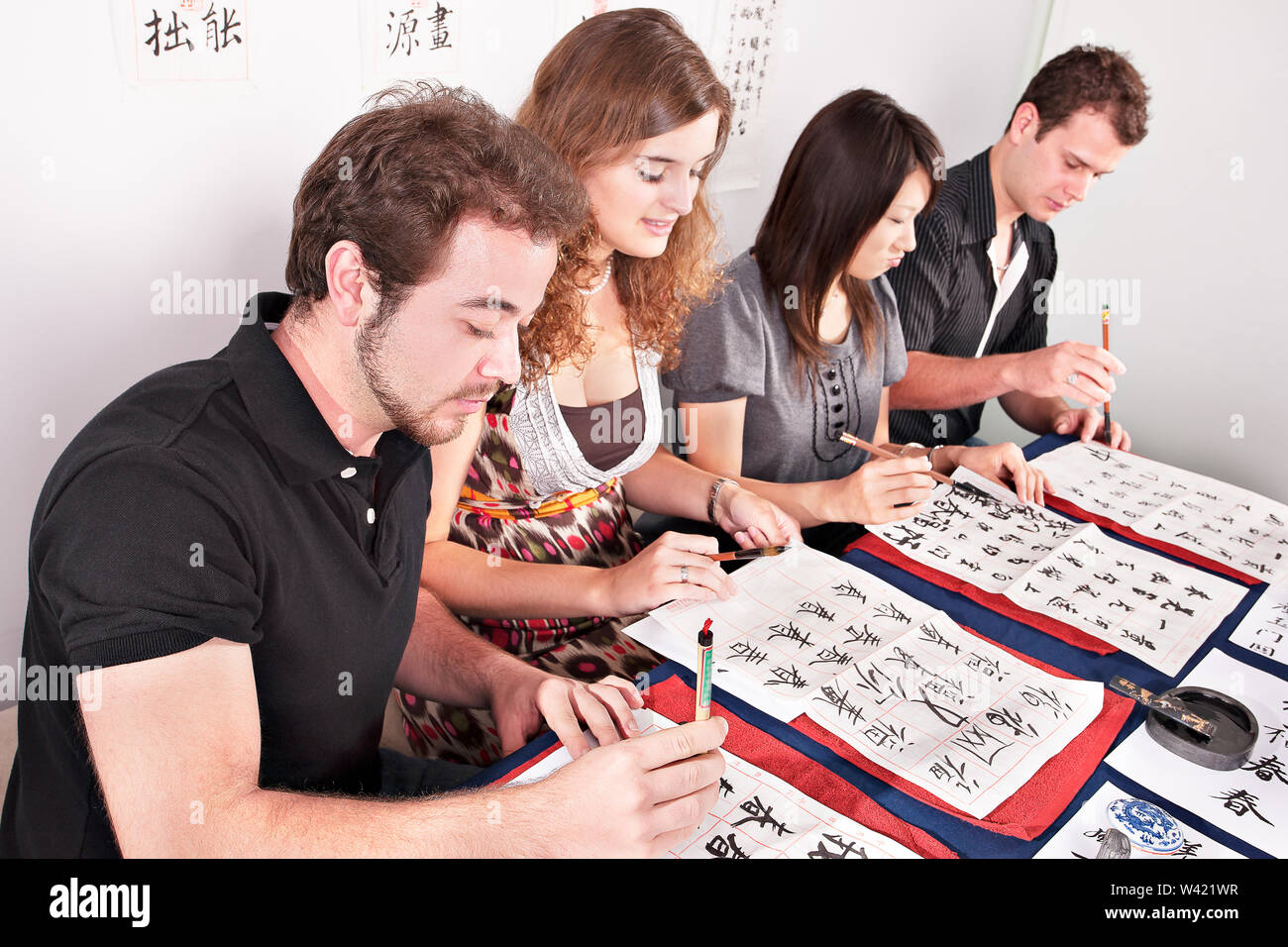 Young school or college girls and boys writing letters like Chinese ...