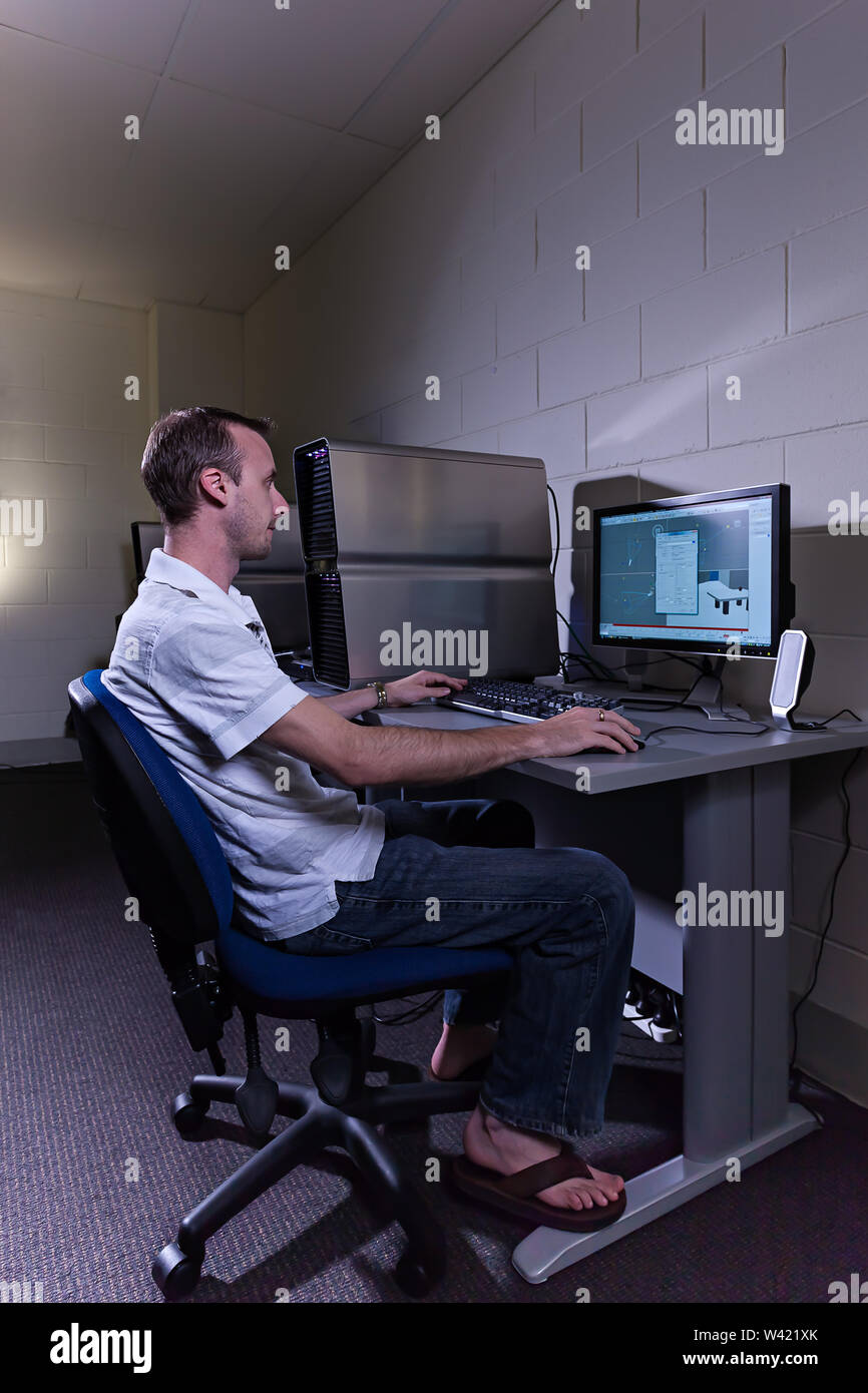 young guy working with a computer focusing on the monitor Stock Photo ...