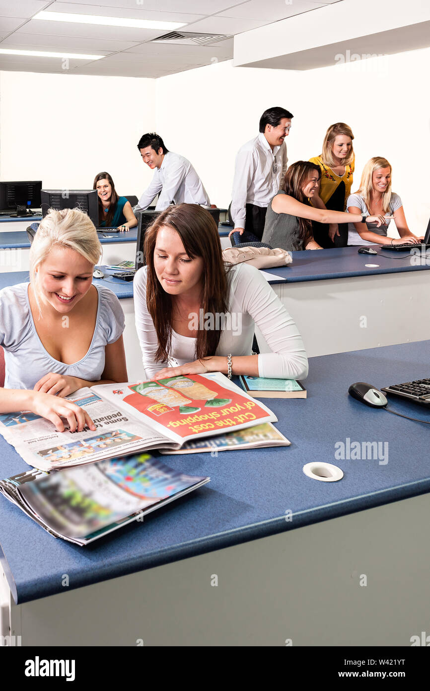 Office crew working happily and reading articles with newspapers to ...