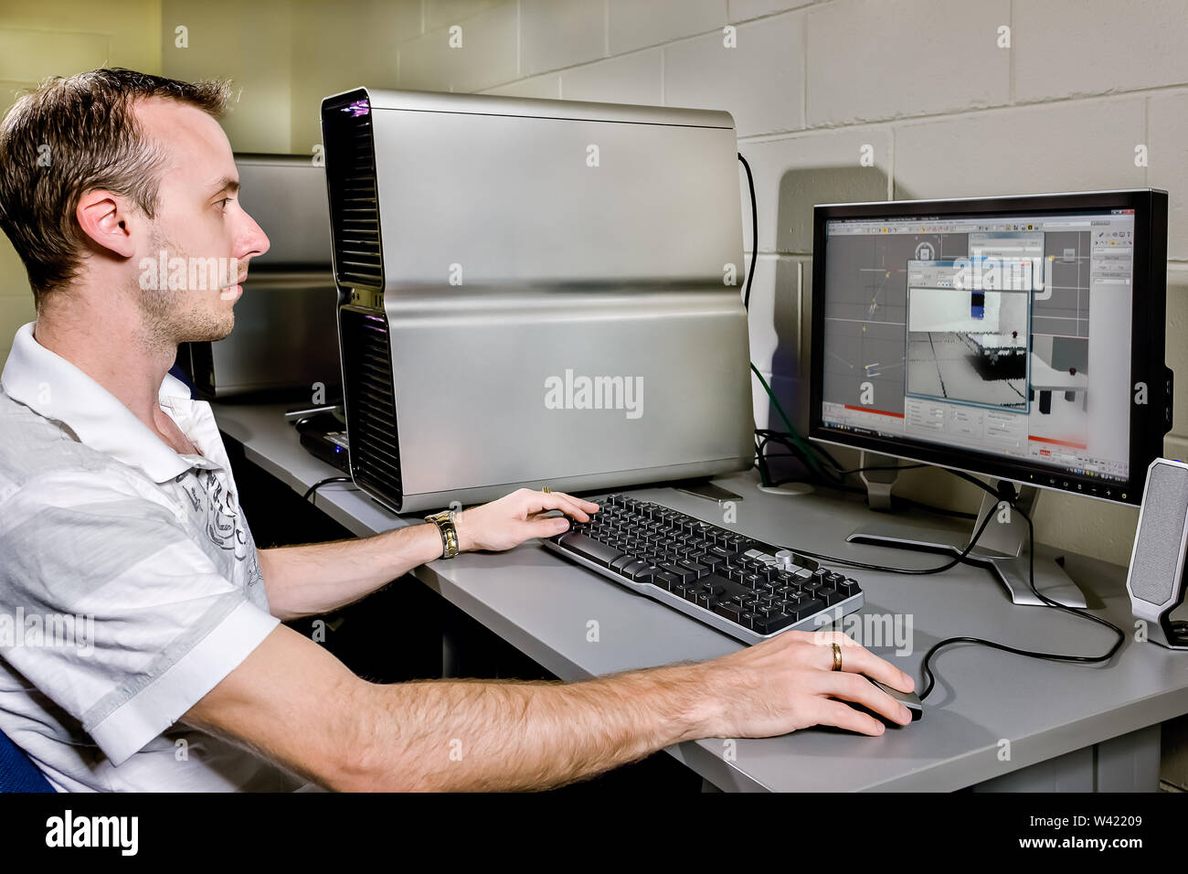 Young man using a private computer with his hands in a room Stock Photo ...