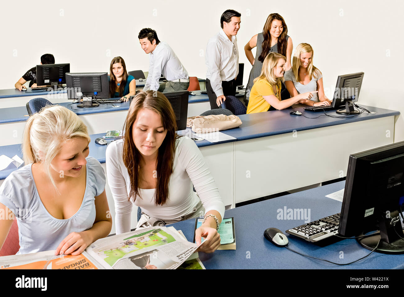 Young workers working in a newspaper department and they are reading ...