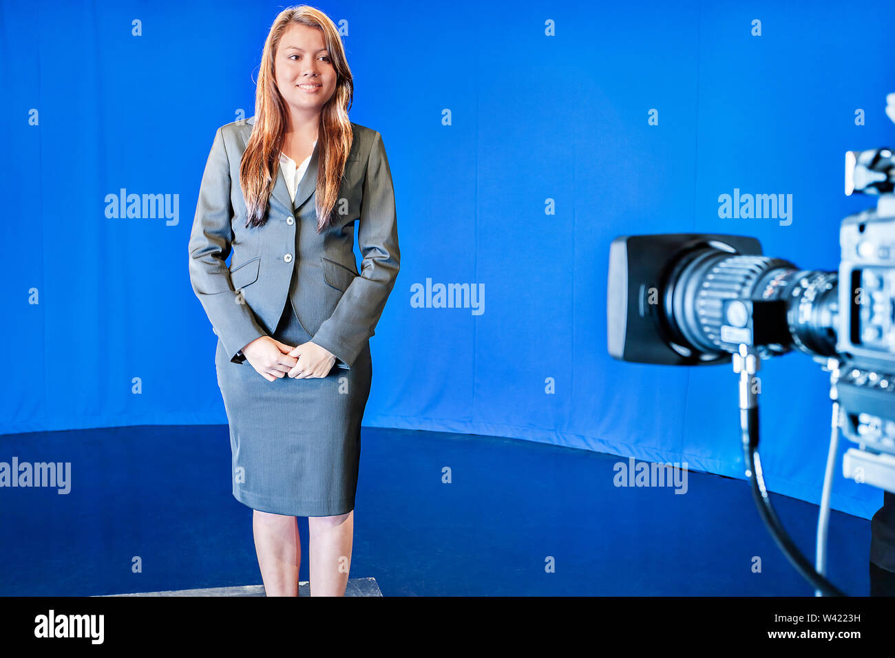 Television presenter lady ready in front of the camera to start the ...