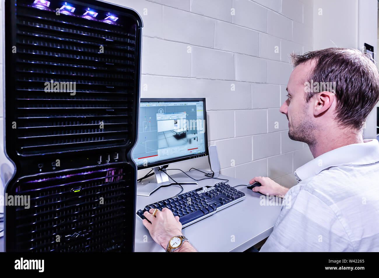 Close up of a computer system unit and the person who sitting and ...