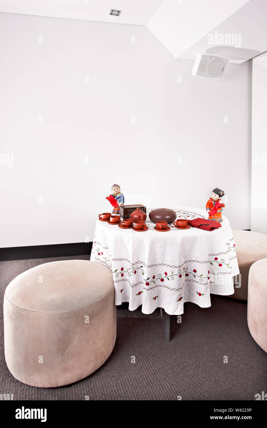 Traditional tea table ready with round cushion chairs and clay cups ...