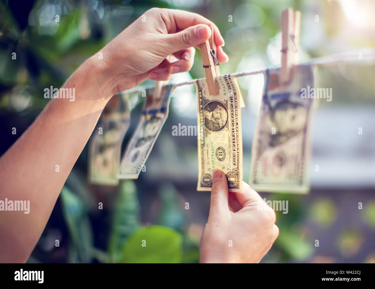 US dollar banknotes hanging on rope for money laundering conept hand ...