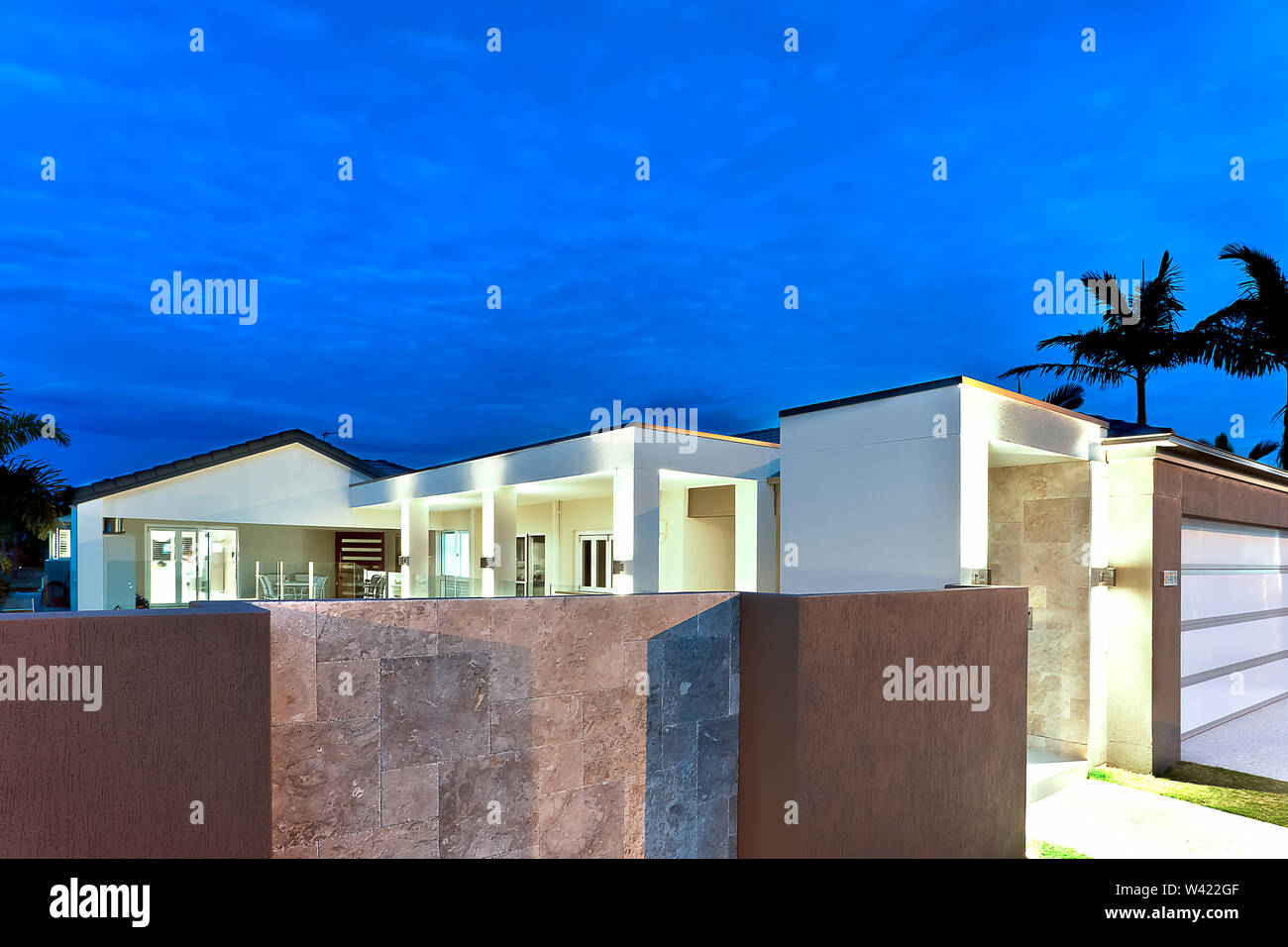 Top view over the wall of a modern house entrance with lights on at ...