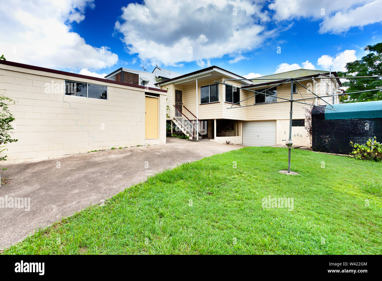A spacious backyard of a simple house, captured at daytime Stock Photo ...