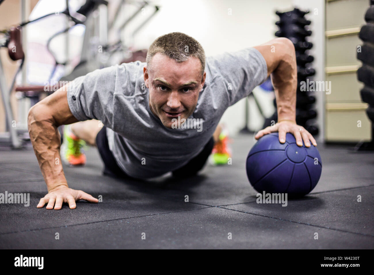 White man work out with push up including ball, inside room of a luxury ...