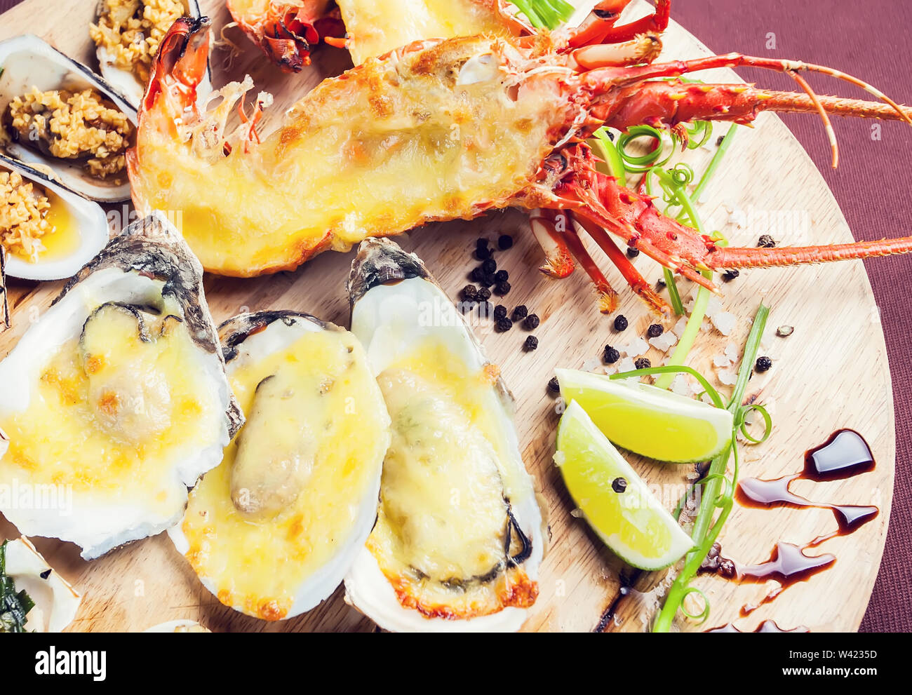 A luxury dish of lobster roasted and decorated with many items of ...