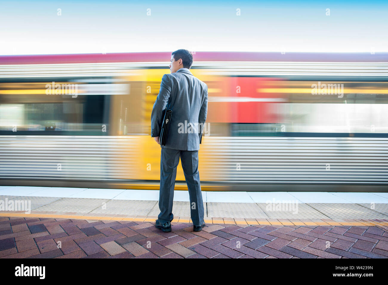 Colorful train going forward at station, sunlight around the area ...