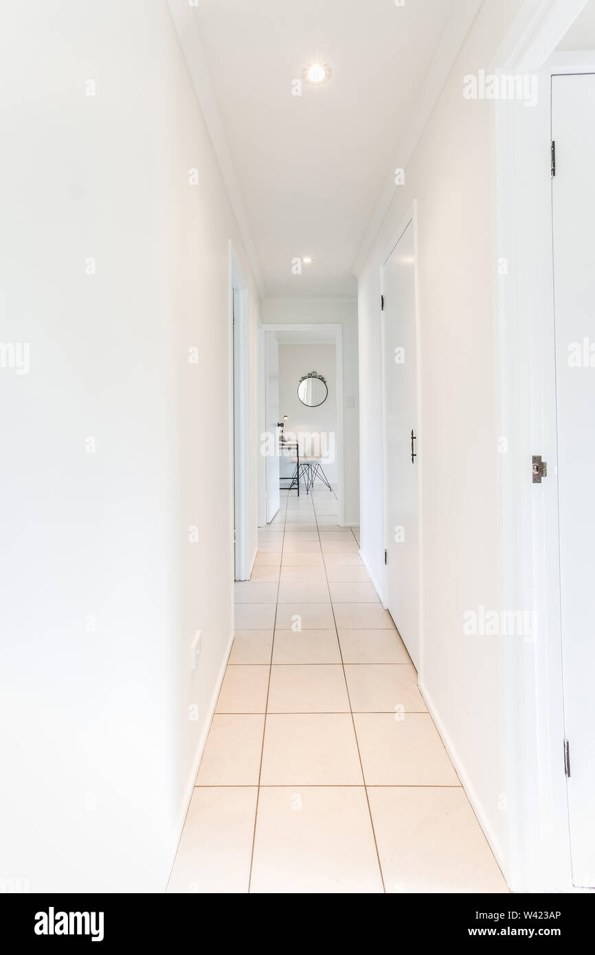 Tiled hallway leading to a study room Stock Photo - Alamy