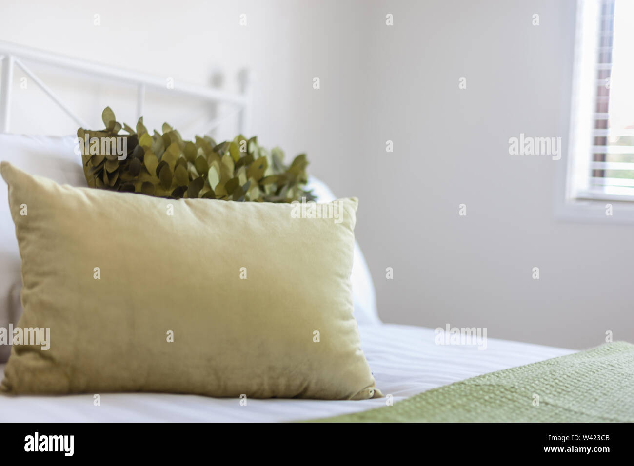 View of two soft and colourful pillows kept on top of plush bedding ...