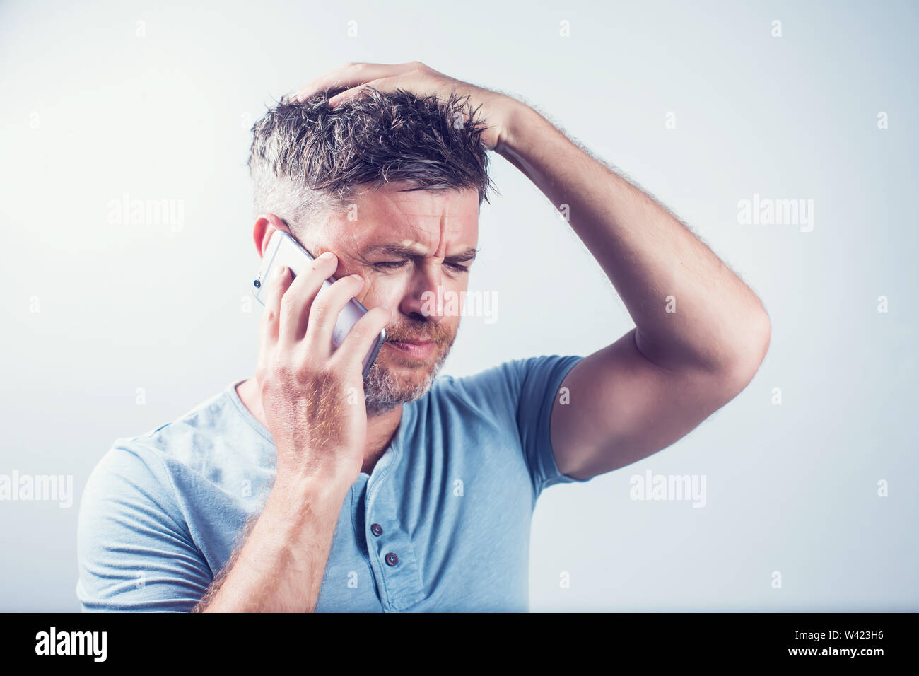 Handsome young man using mobile phone feel sad Stock Photo - Alamy
