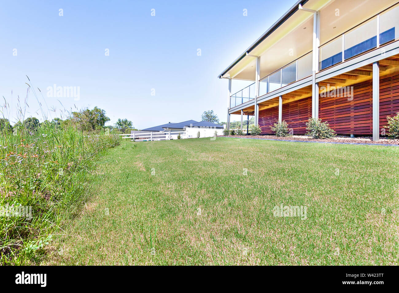 Shiny ground with grass infront of apartment, garden have beautiful ...