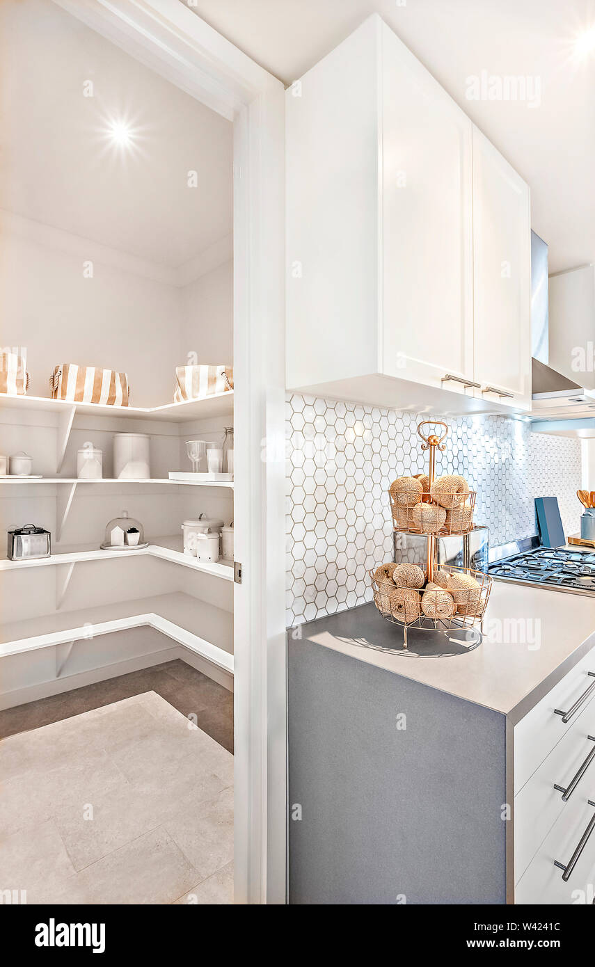 Luxury kitchenware and utensils beside cooking ingredient store shelves ...