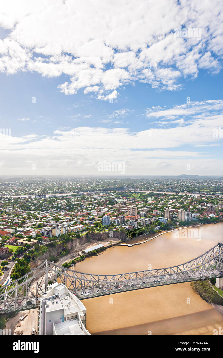 Long bridge on muddy water near city and sky, river is brown color with ...
