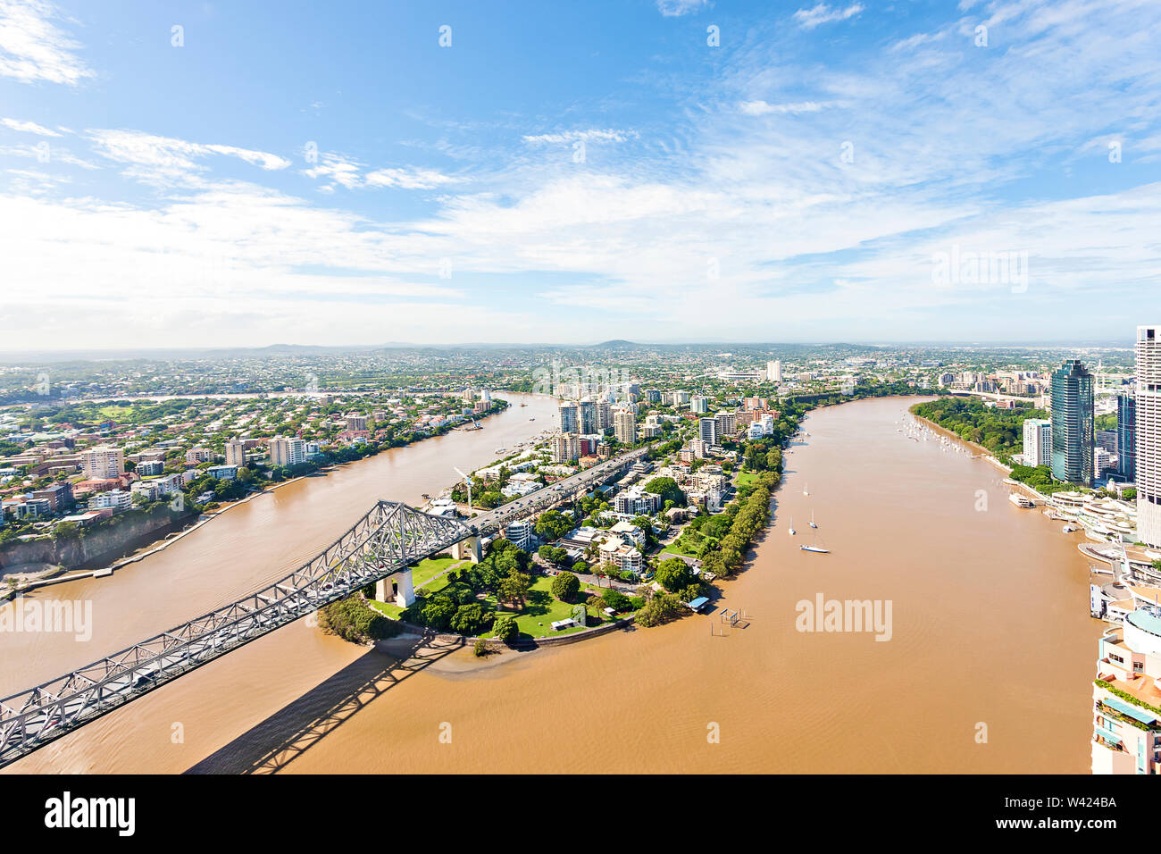 Hard bridge with buildings and green gardens, lots of green trees have ...