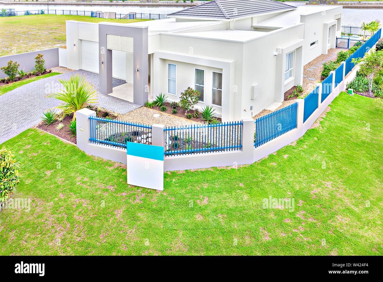 Natural garden with plants, home front ground wall with metal fence ...