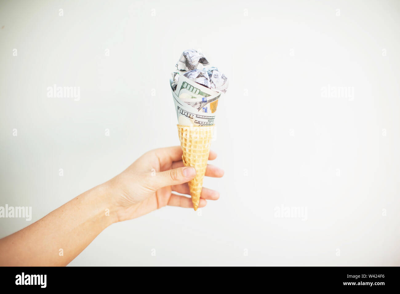 Monetary wafers. dollar bills rolled in ice cream cone Stock Photo - Alamy