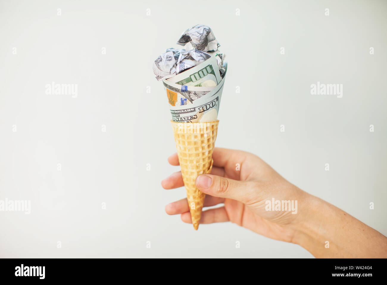 Monetary wafers. dollar bills rolled in ice cream cone Stock Photo - Alamy