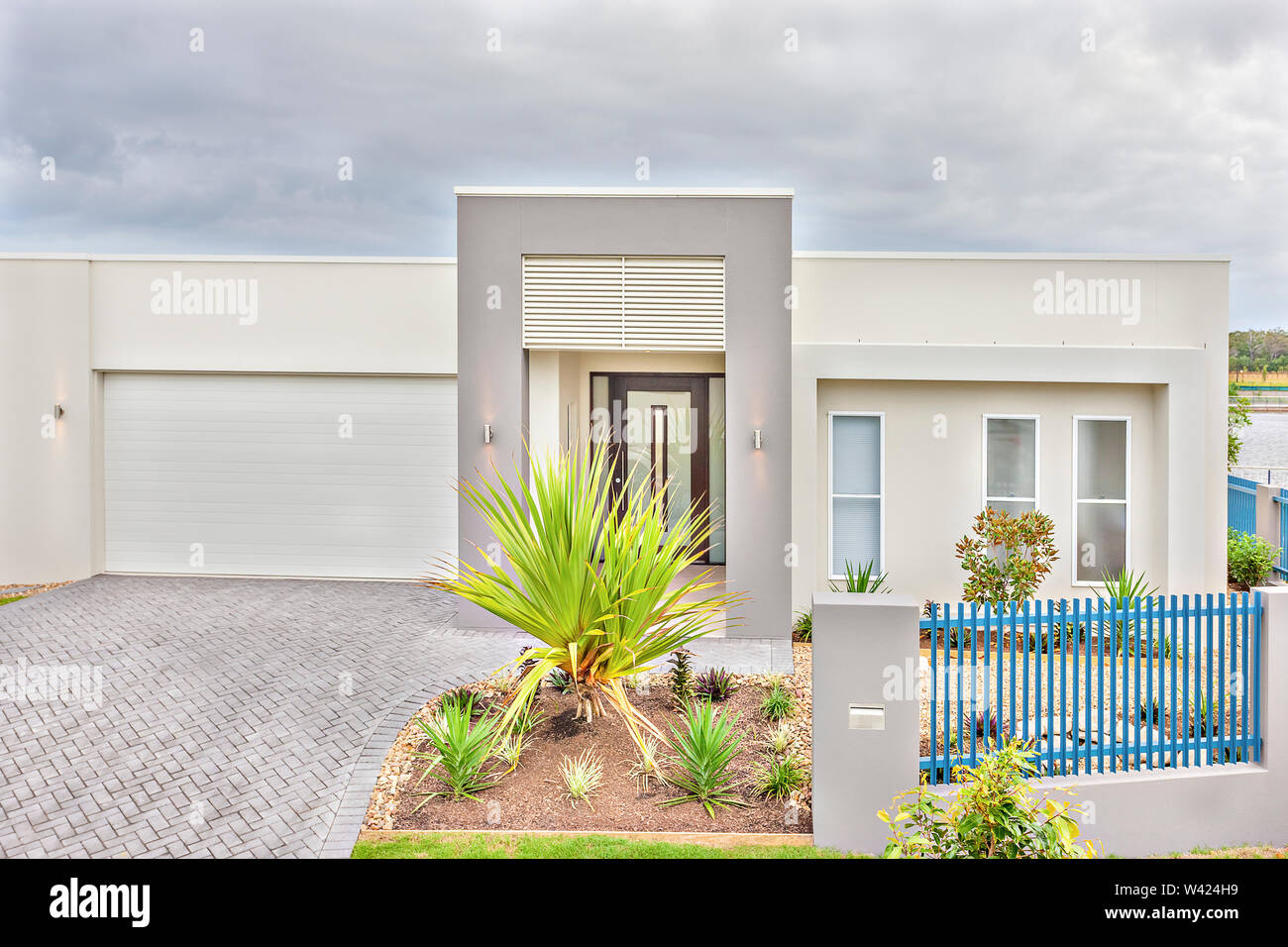 Front view of a classic house, sky has white clouds also blue color ...