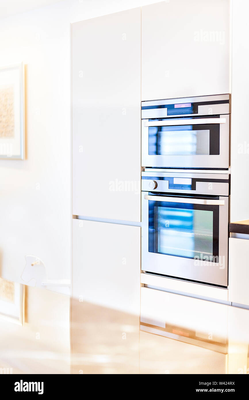 Modern kitchen ovens in the pantry cupboard, wall close up near the ...