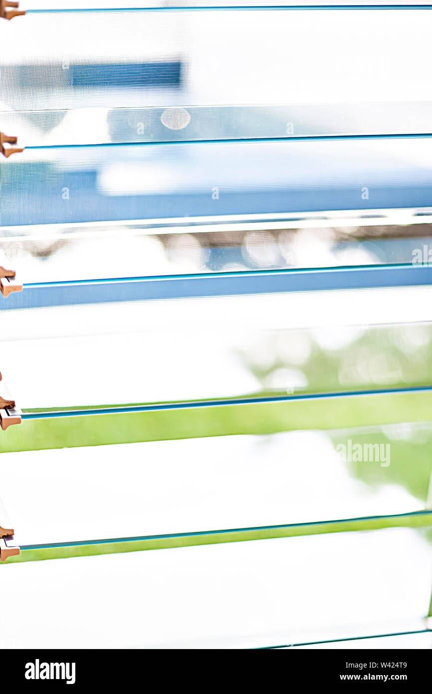 Glass window panels open and view of outside blurred and bright close ...