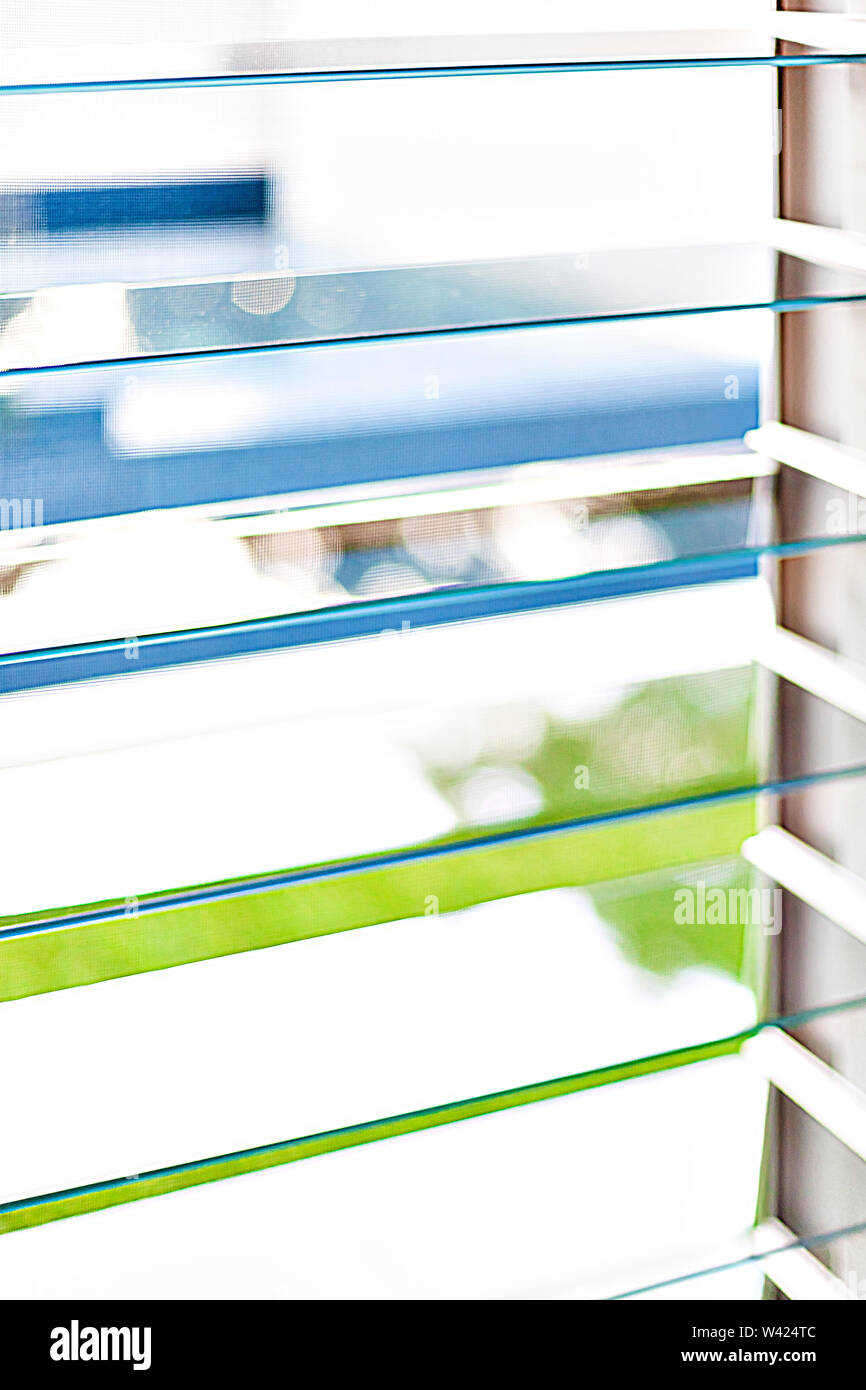 Glass window panels open and view of outside blurred and bright close ...