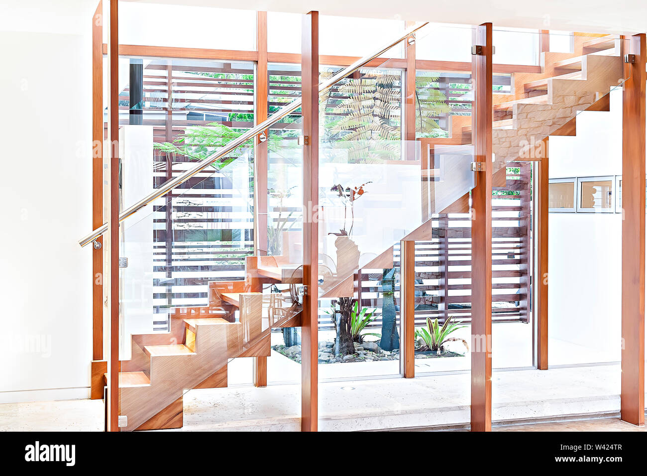 Wooden stairs with the glass window panels and cover, the steps go ...