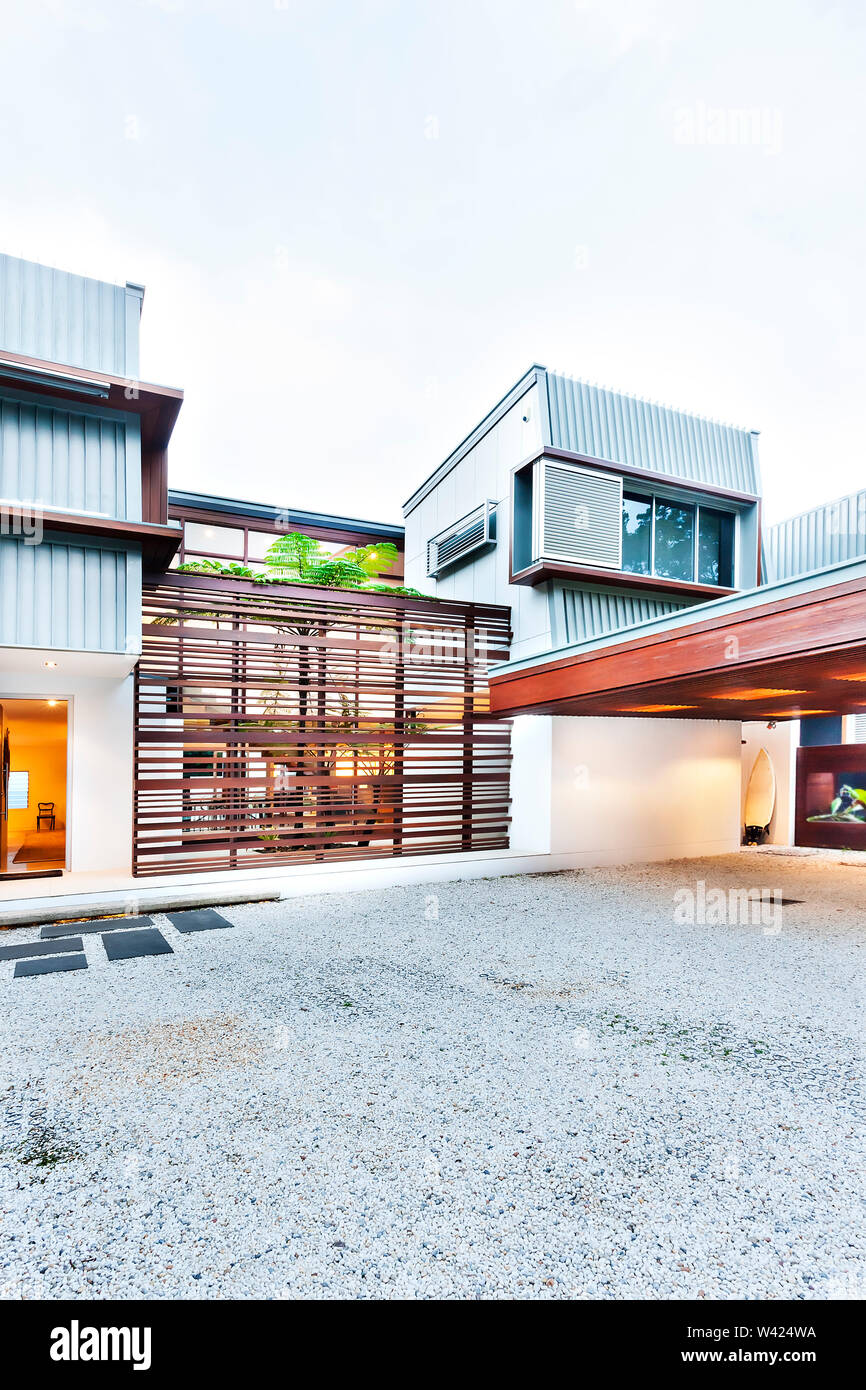 Stone floor entrance through the wooden gate to a factory with tall ...