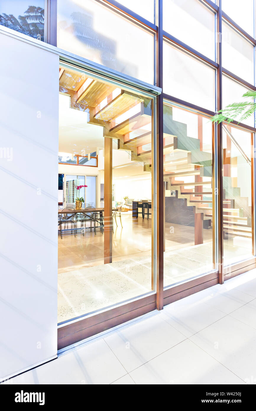 Large glass windows of a luxury house view from outside with a tile ...