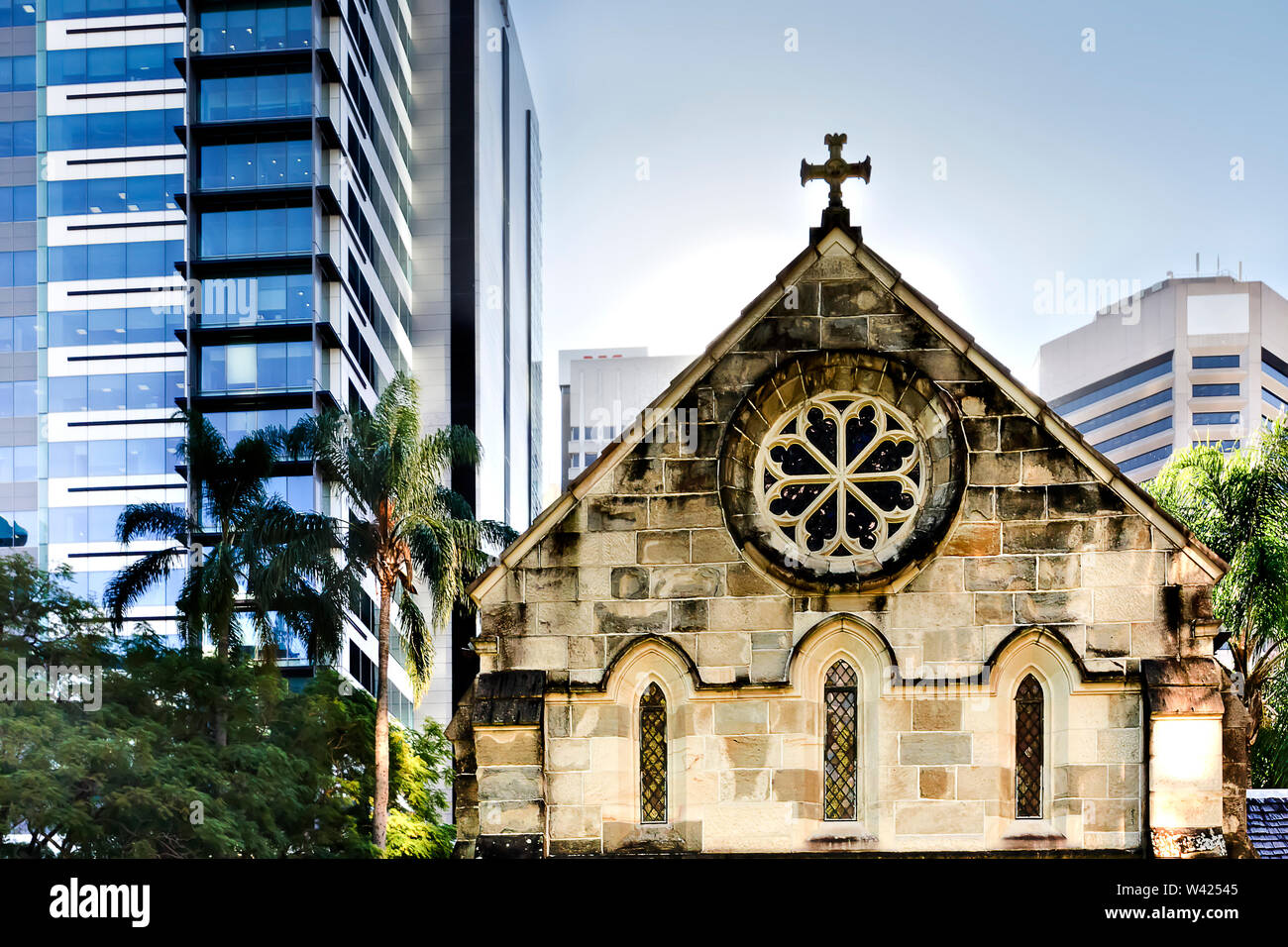 Old church architecture building with palm trees and skyscraper Stock ...