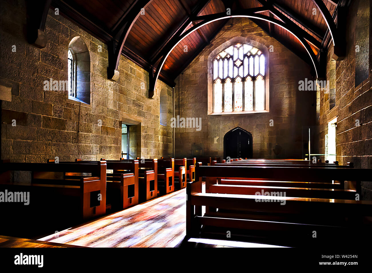 Old hall like church with wooden roof and long benches on the floor ...